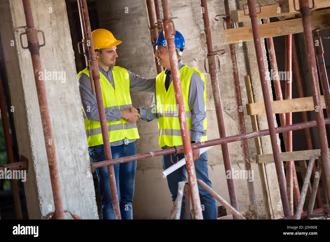 Investor and architect making agreement under building construction ...