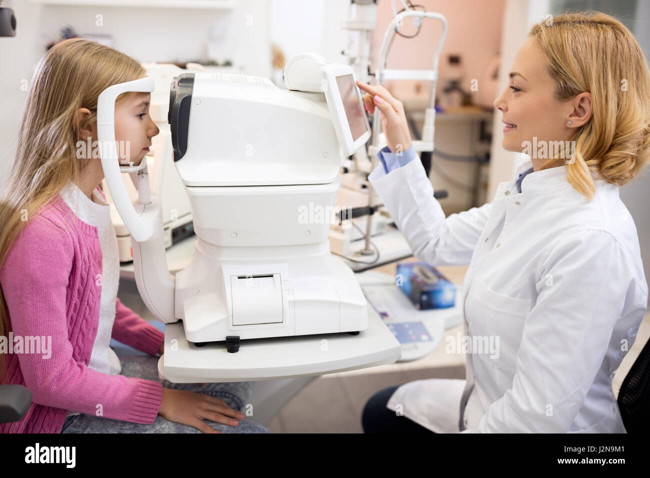Female doctor checkup eyesight of girl on ophthalmologist at clinic ...