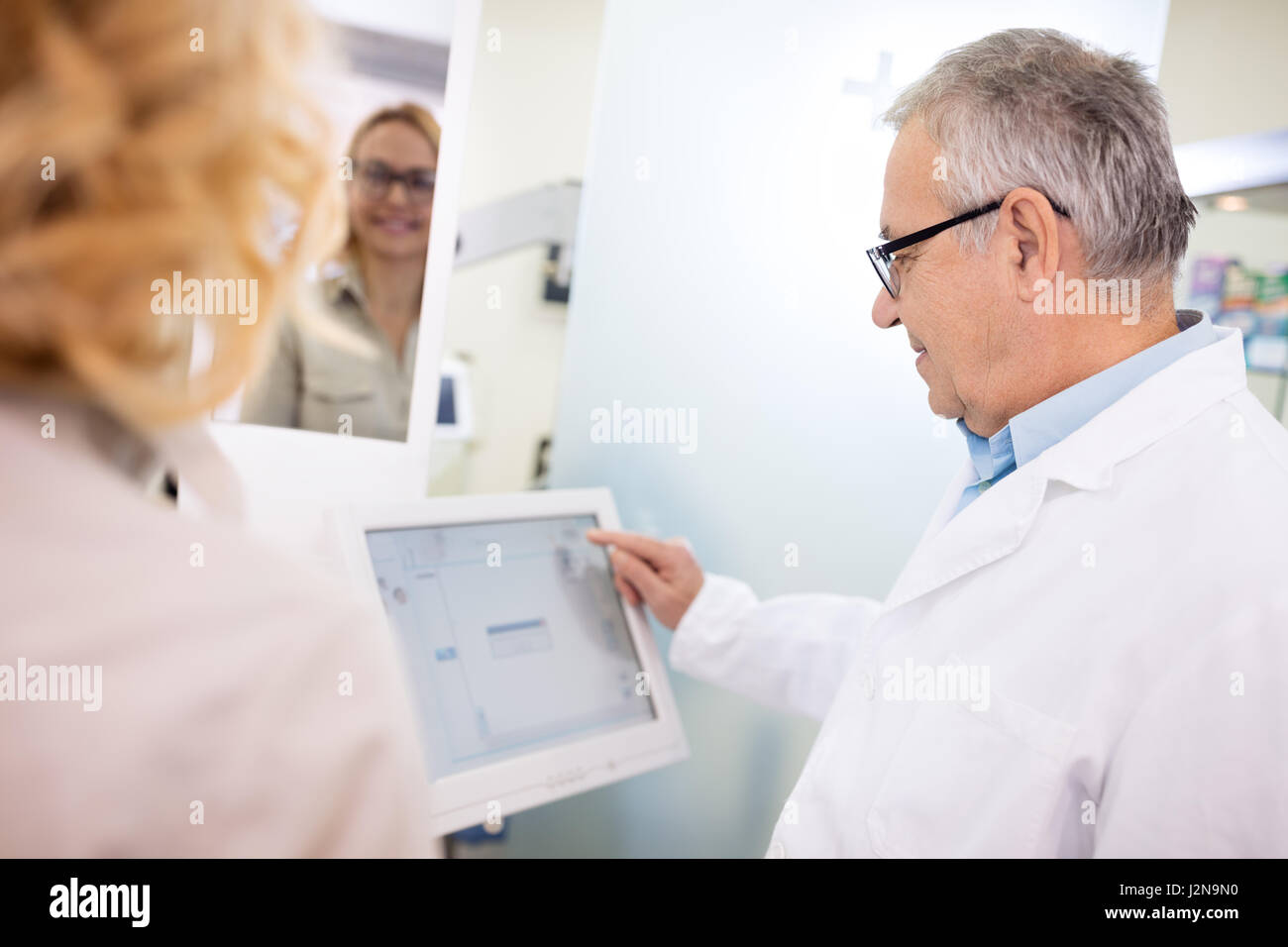 Male eye doctor show results of optical review to patient Stock Photo ...