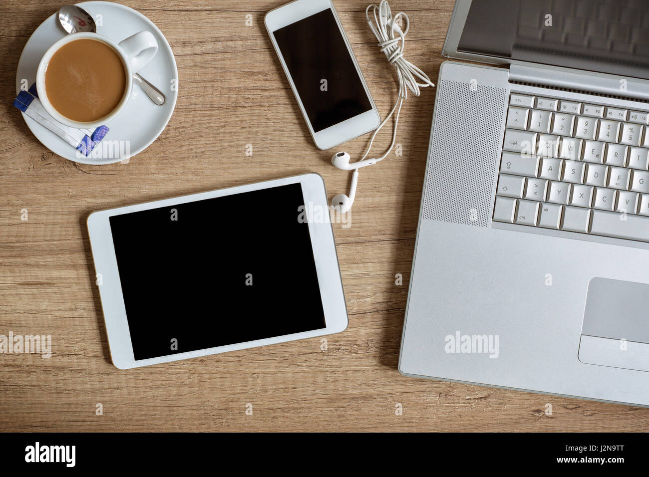 Laptop smartphone and coffee cup on wood background Stock Photo - Alamy