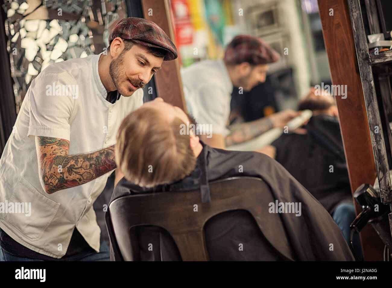 Barbershop customer sitting on chair hi-res stock photography and ...