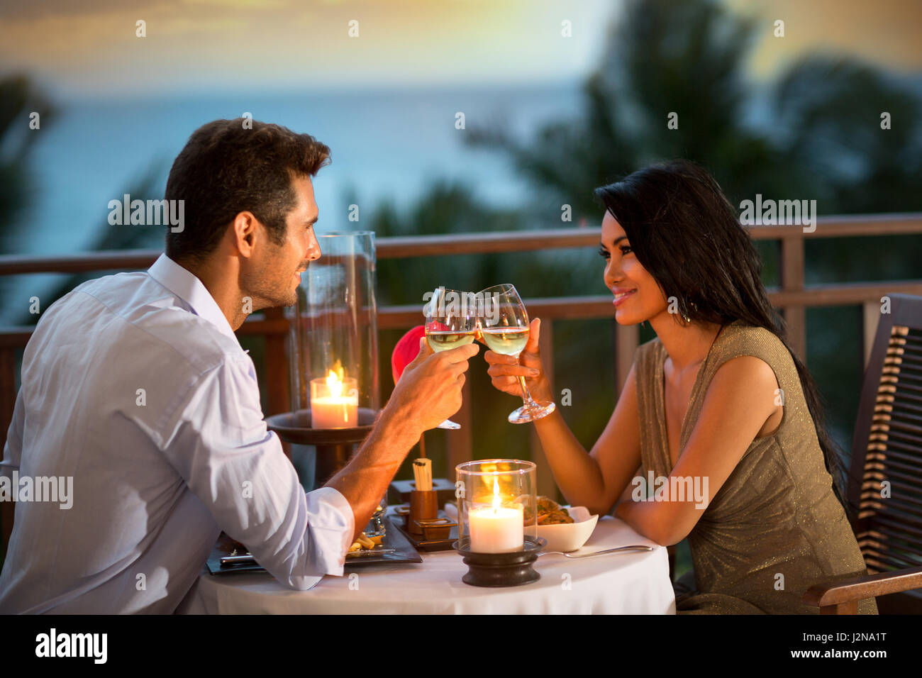 Young , romantic couple toasting during dinner on tropical resort Stock ...