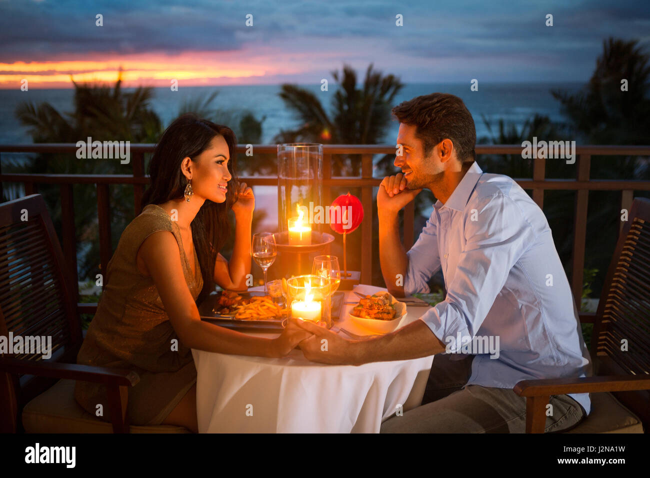 Romantic couple have dinner with sunset and candlelight outdoor ...