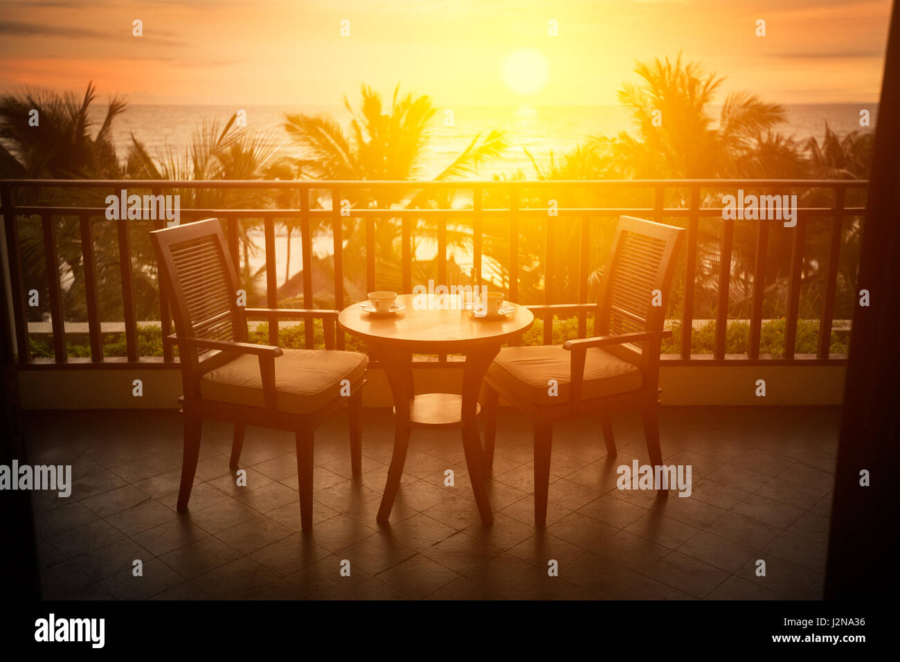 romantic table on terrace, sunset in background Stock Photo - Alamy