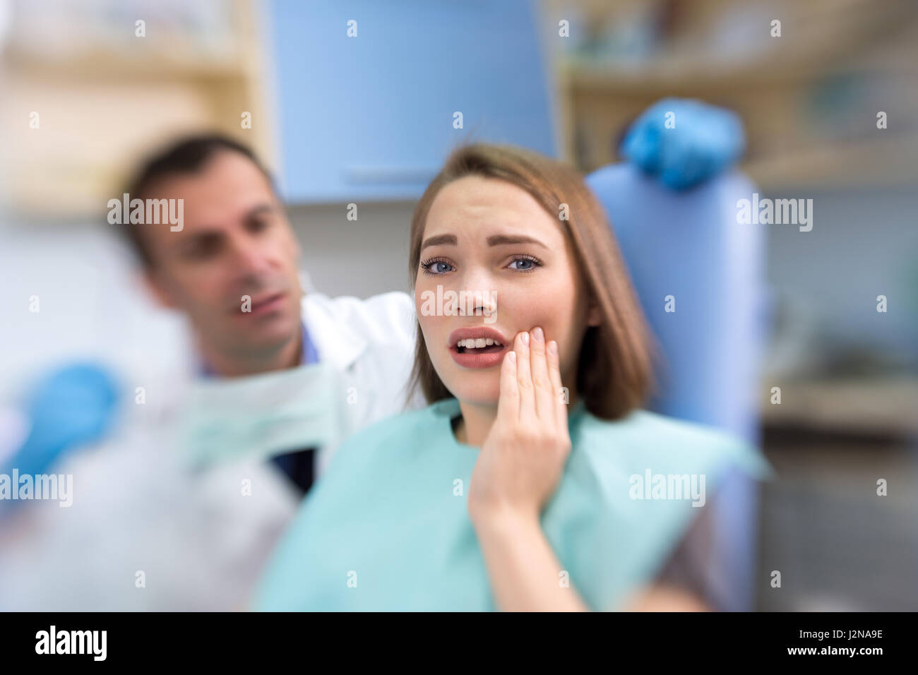 Close up of young female patient with toothache and pain in dental ...