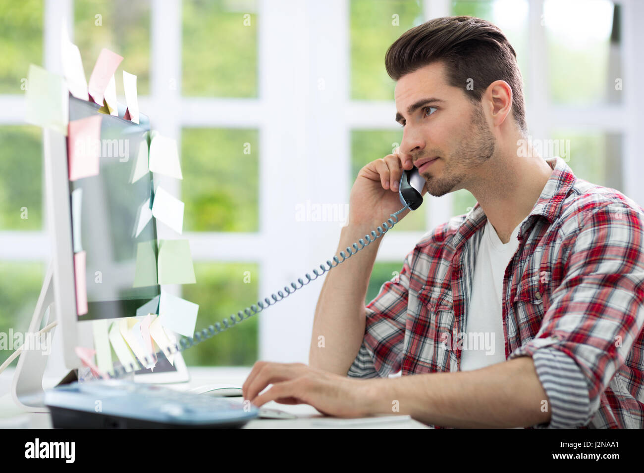 Busy man working on computer Stock Photo - Alamy
