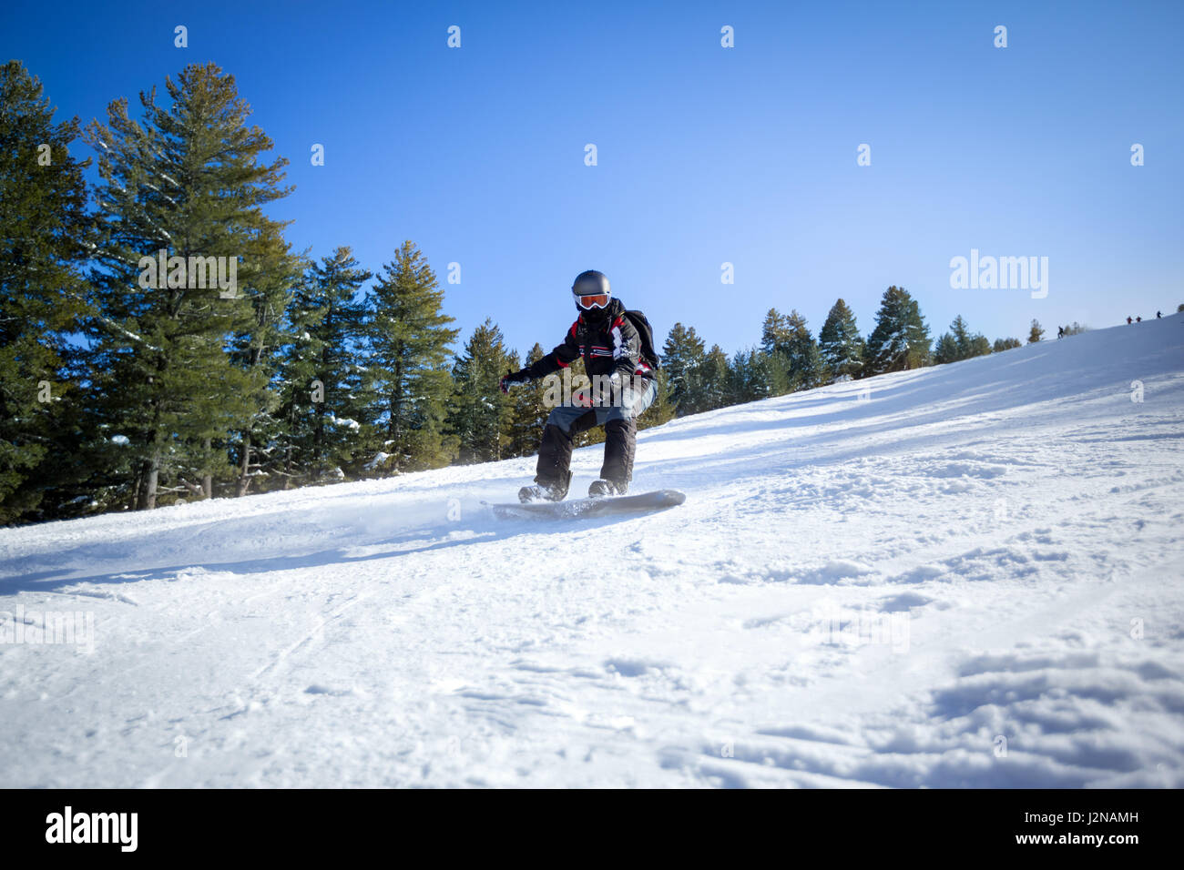 Sportsman snowboarding on the slope Stock Photo - Alamy