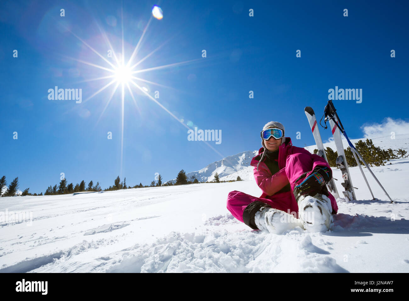 Ski, snow and sun - resting female skier in winter resort Stock Photo ...