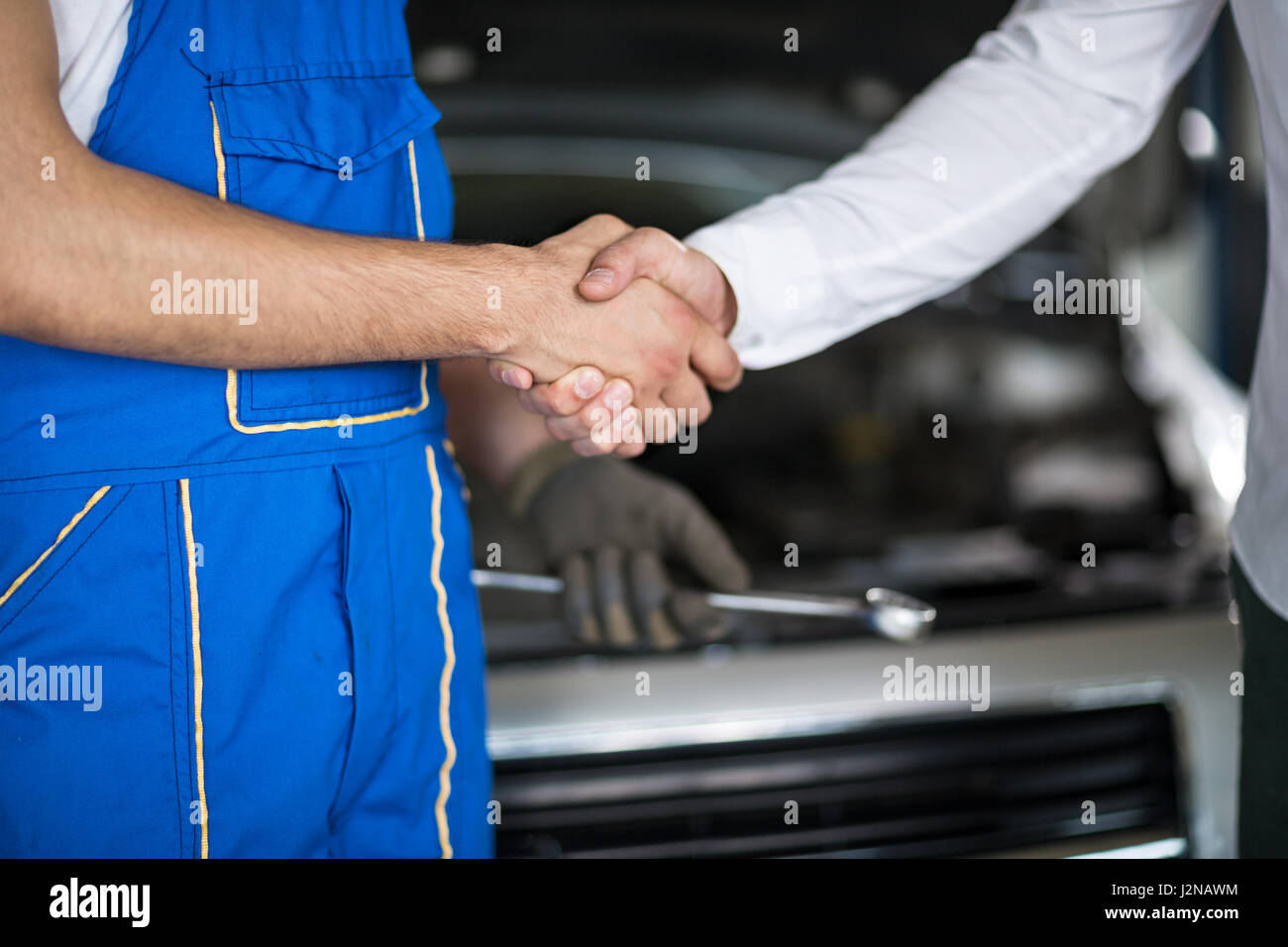 guys handshake in auto repair service Stock Photo - Alamy