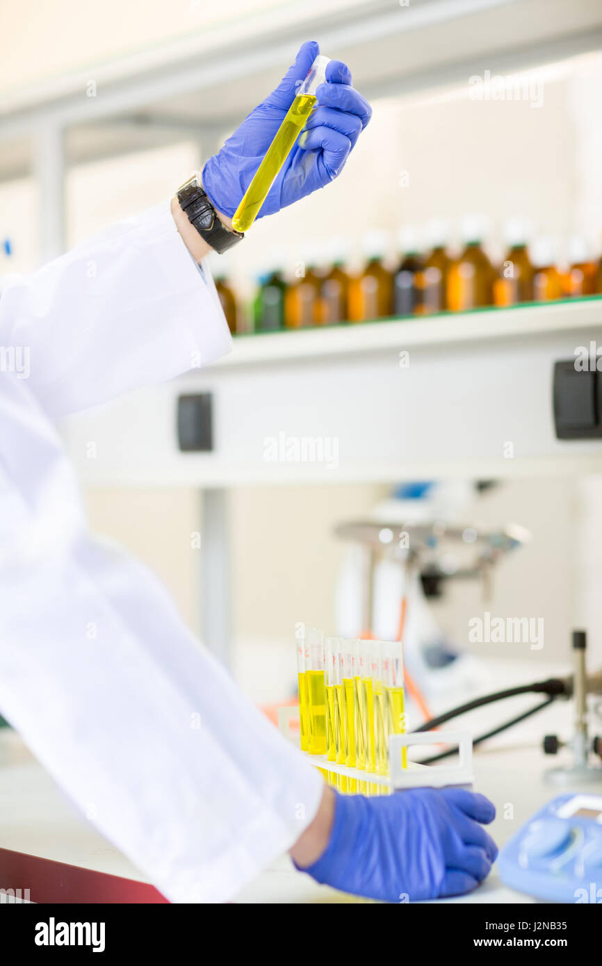 Checking content of test tube in lab Stock Photo - Alamy