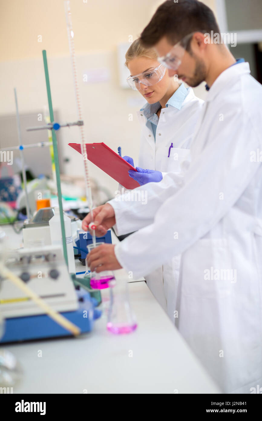 Lab worker testing and measuring fluid in lab Stock Photo - Alamy