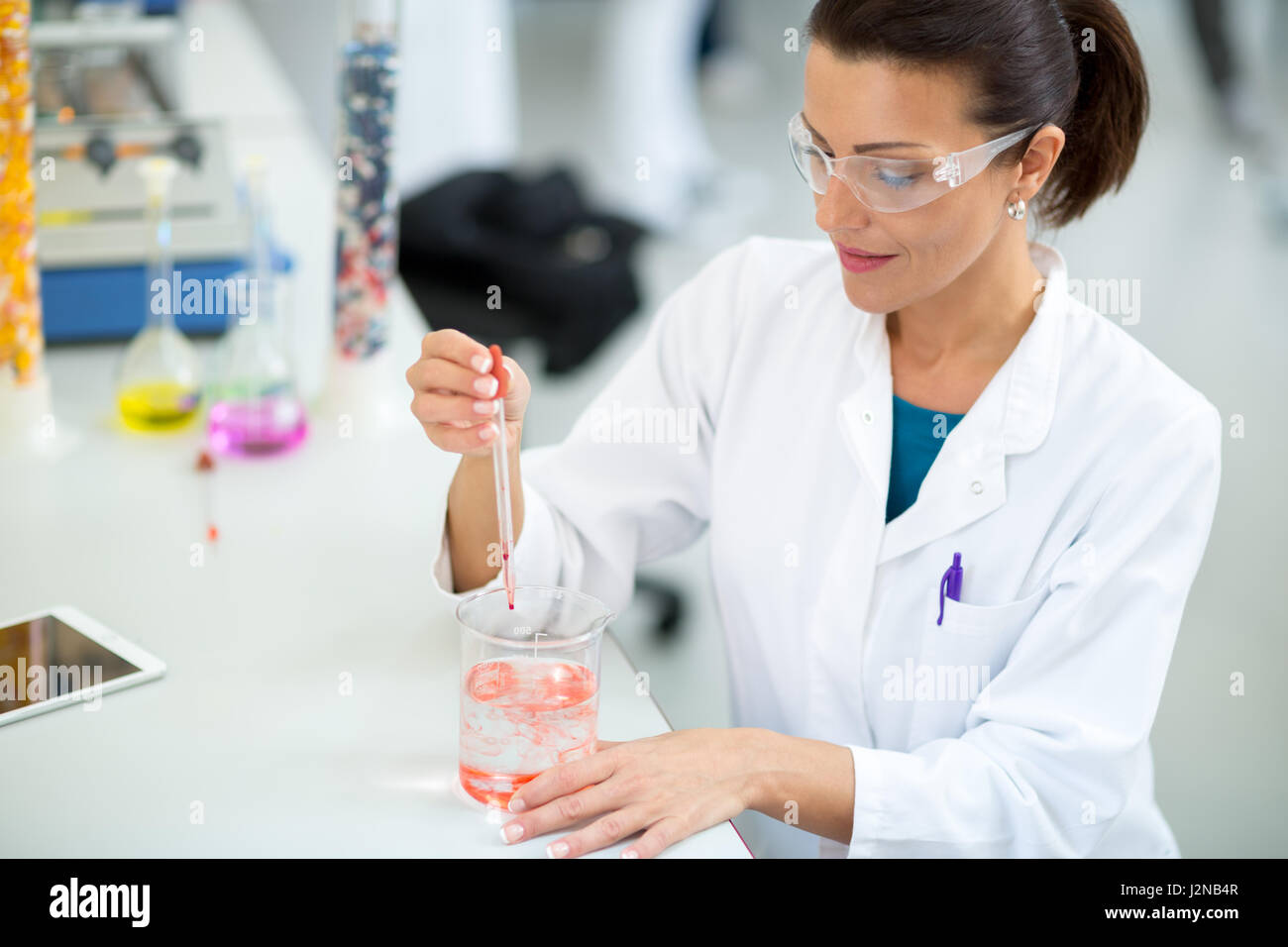 Female worker working in lab with pipette Stock Photo - Alamy