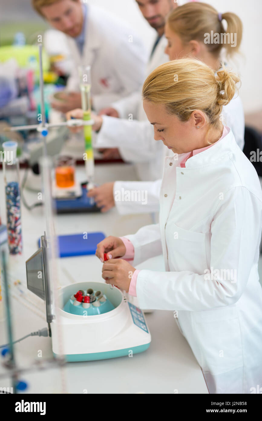 Female technicians work with prepare test tubes for shaker in ...