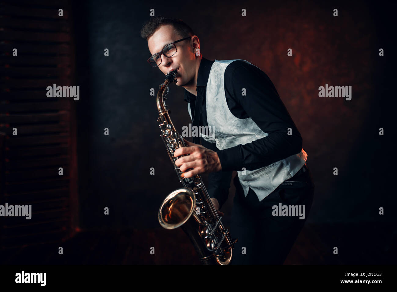 Male saxophonist playing classical jazz melody on sax. Jazz-man concept ...