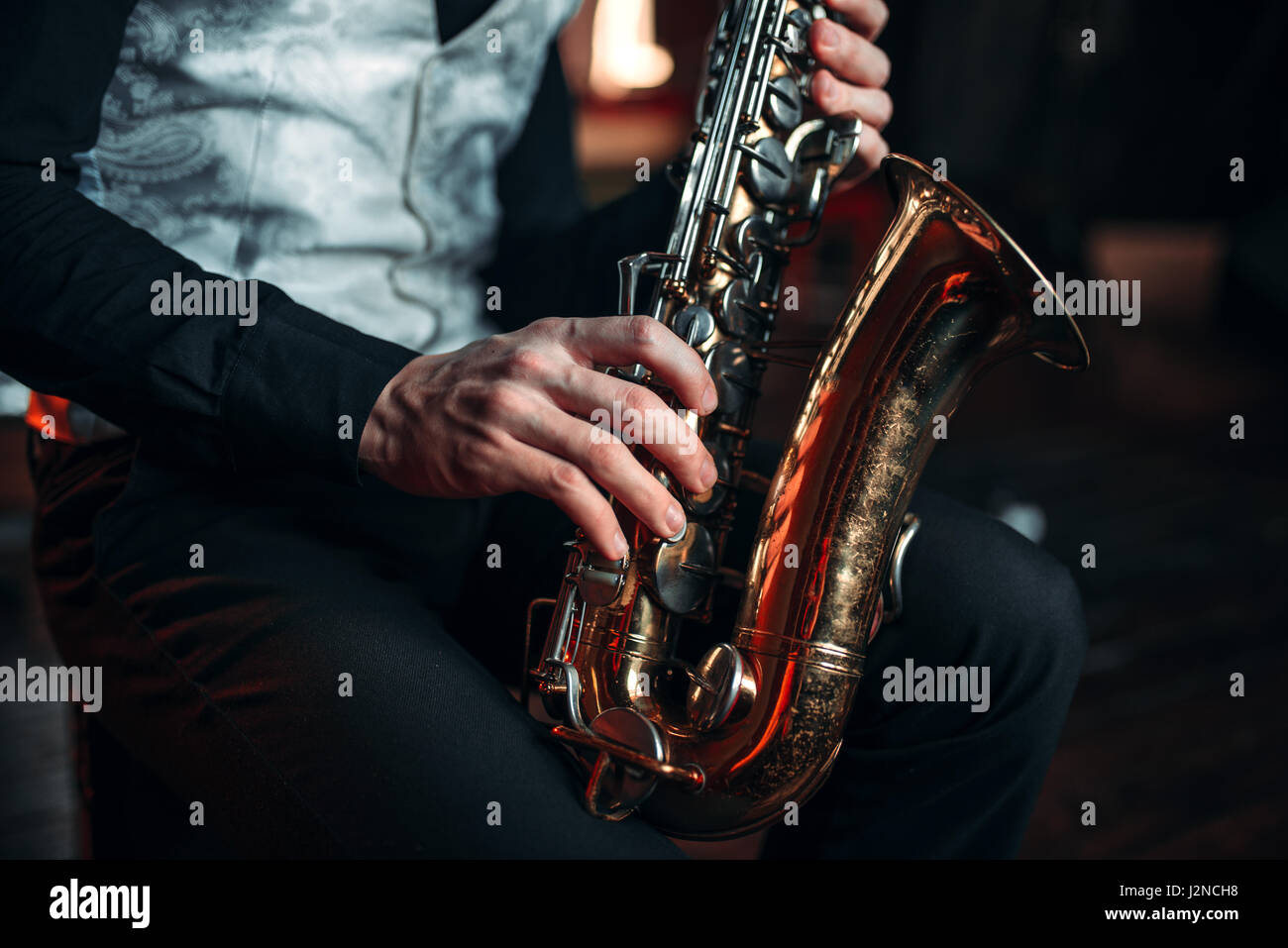 Jazz man hands holding saxophone closeup. Brass band musical instrument ...