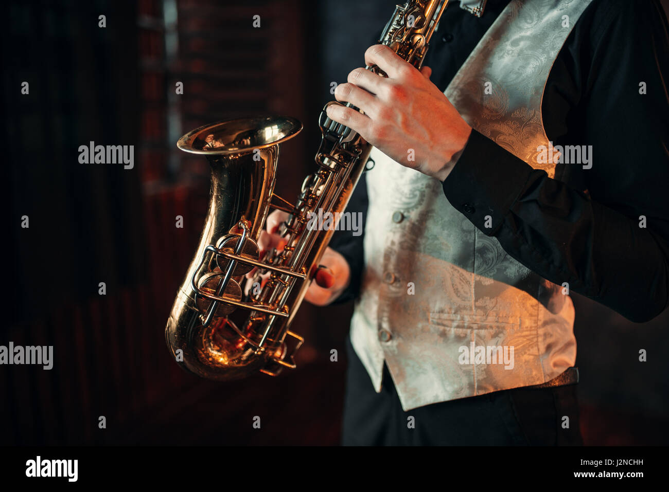 Jazz man hands holding saxophone closeup. Brass band musical instrument ...