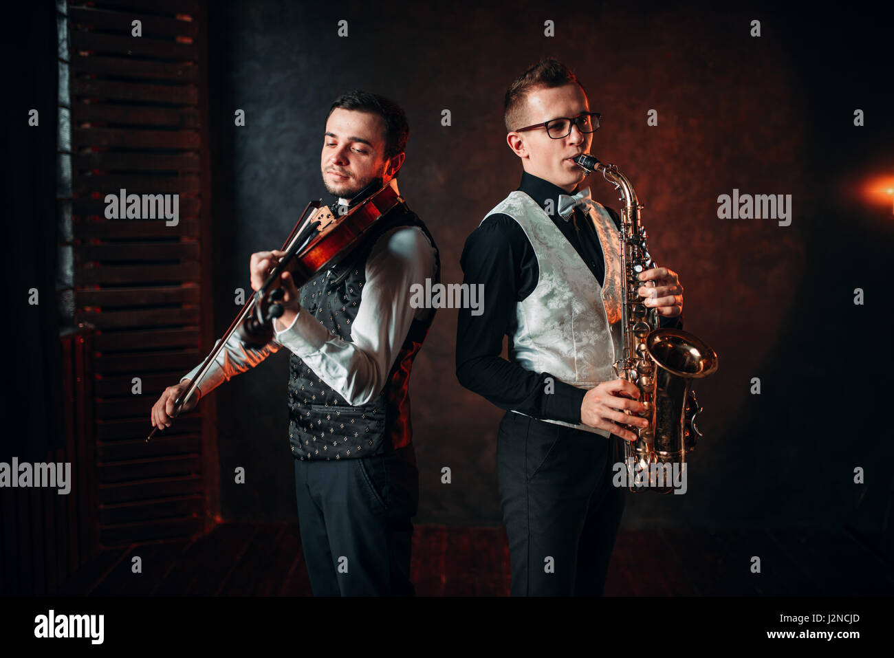 Saxophonist and violinst playing classical melody, musical duet. Jazz ...