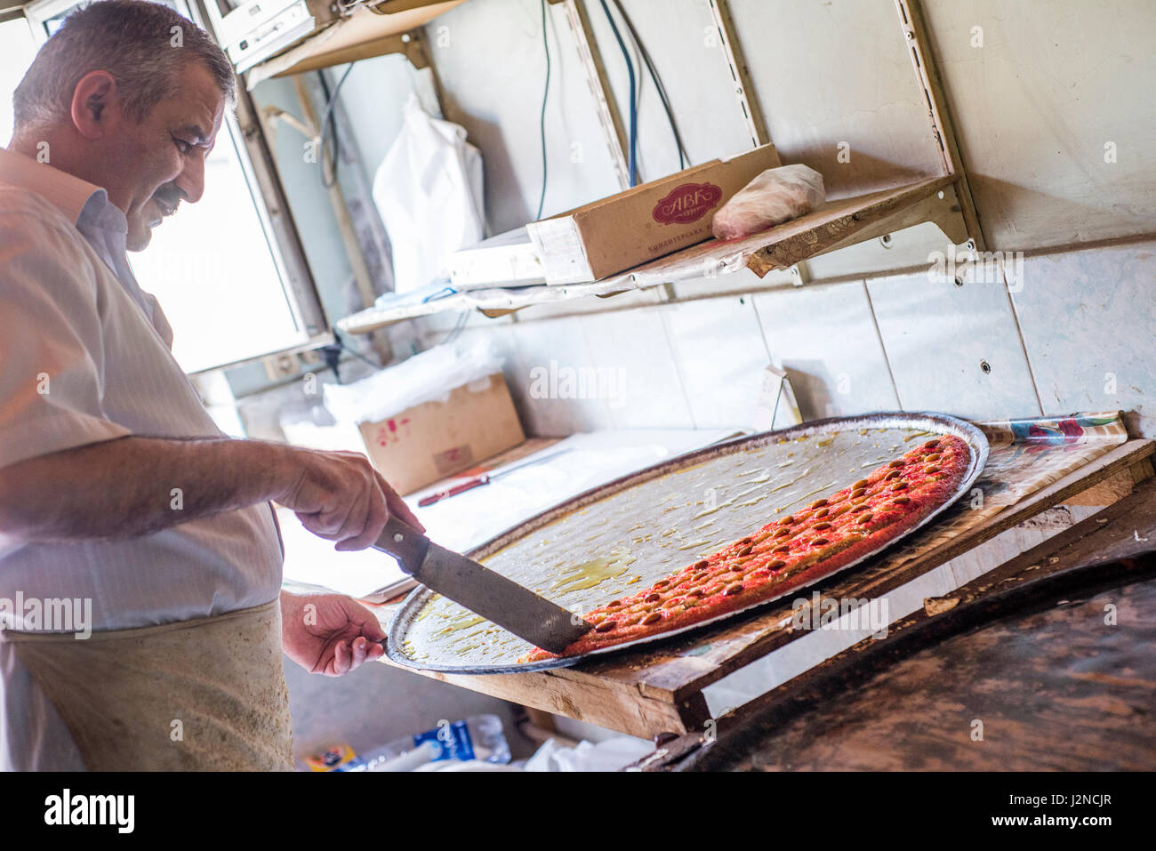 Rustam Hasanov, a baklava master, prepares the pastry at his kitchen ...