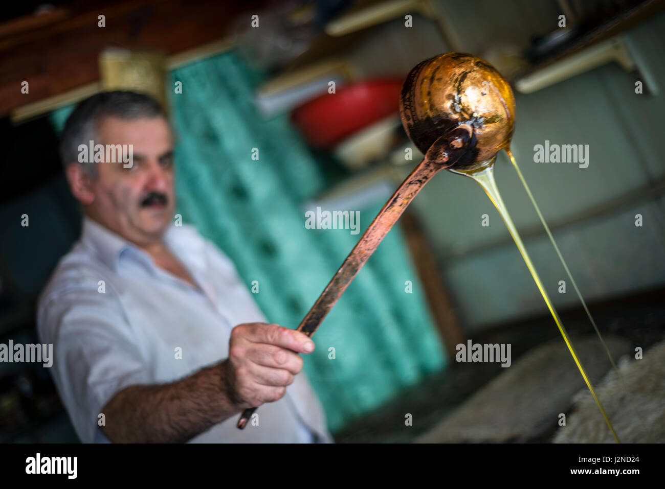 Rustam Hasanov, a baklava master, prepares the pastry at his kitchen ...
