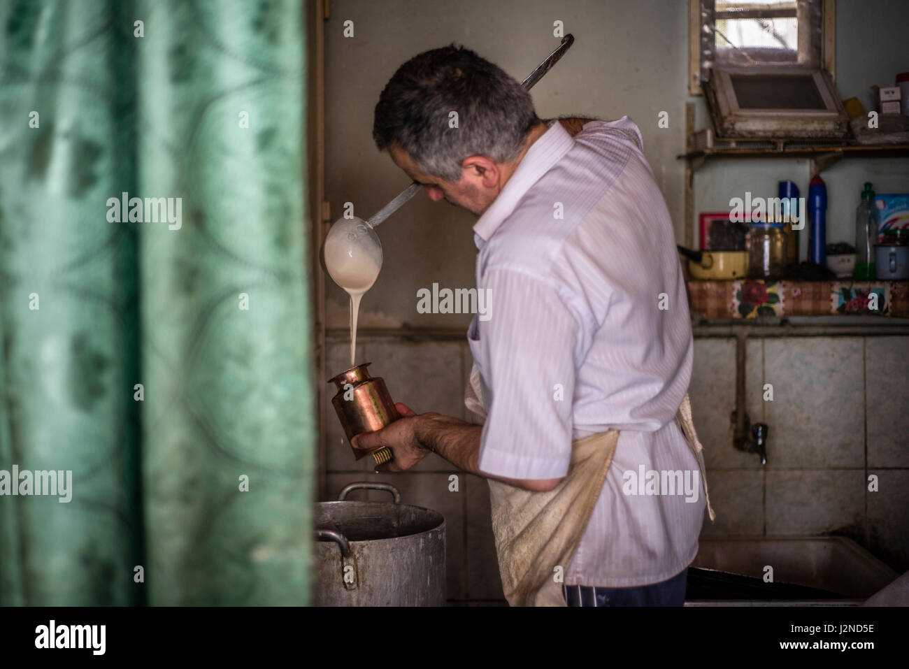 Rustam Hasanov, a baklava master, prepares the pastry at his kitchen ...