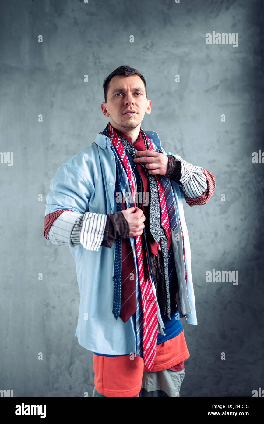 Man dressed in many clothes choosing tie. Shopping concept Stock Photo ...