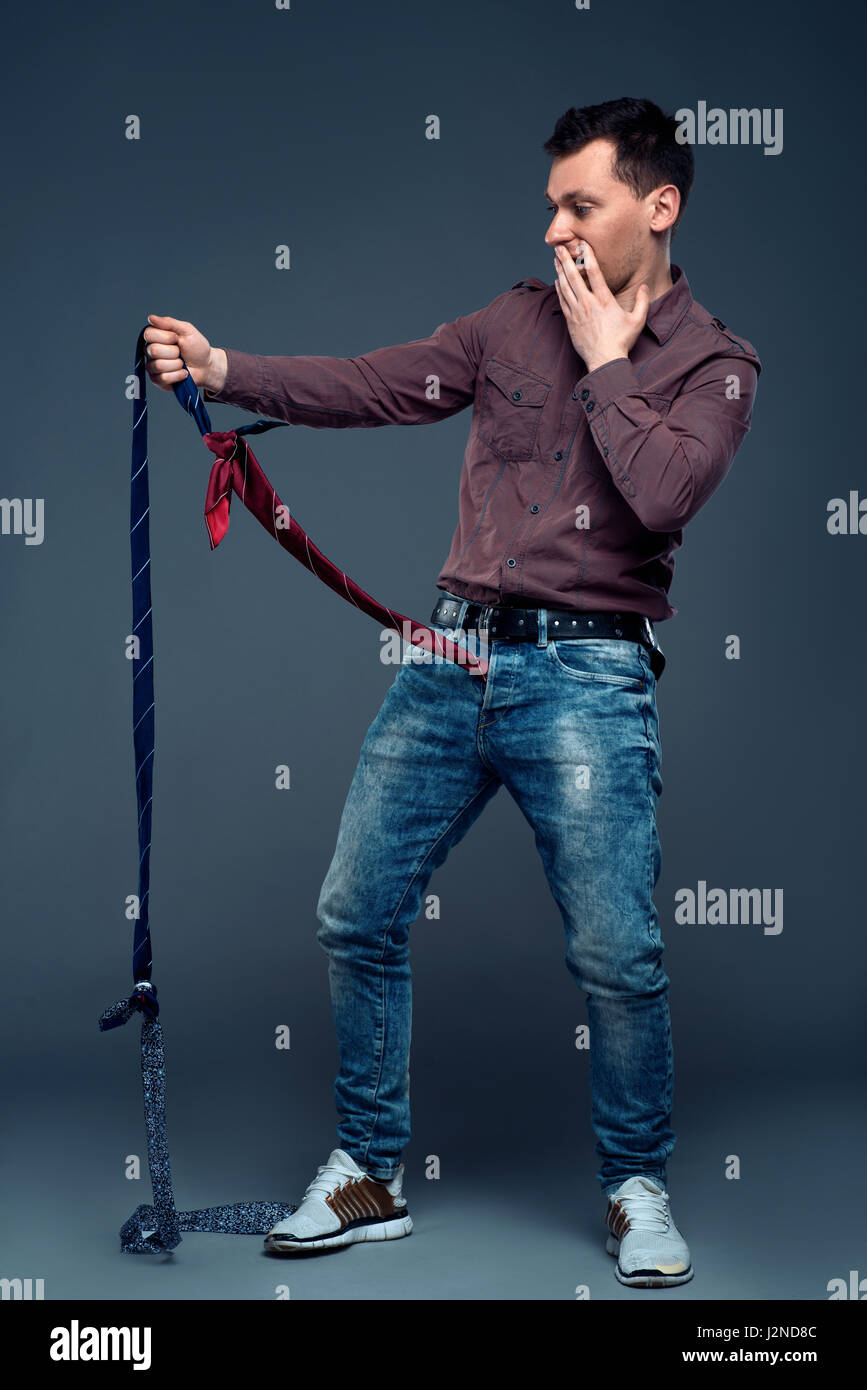 Man can not choose tie at the clothes shop. Problem with choice ...