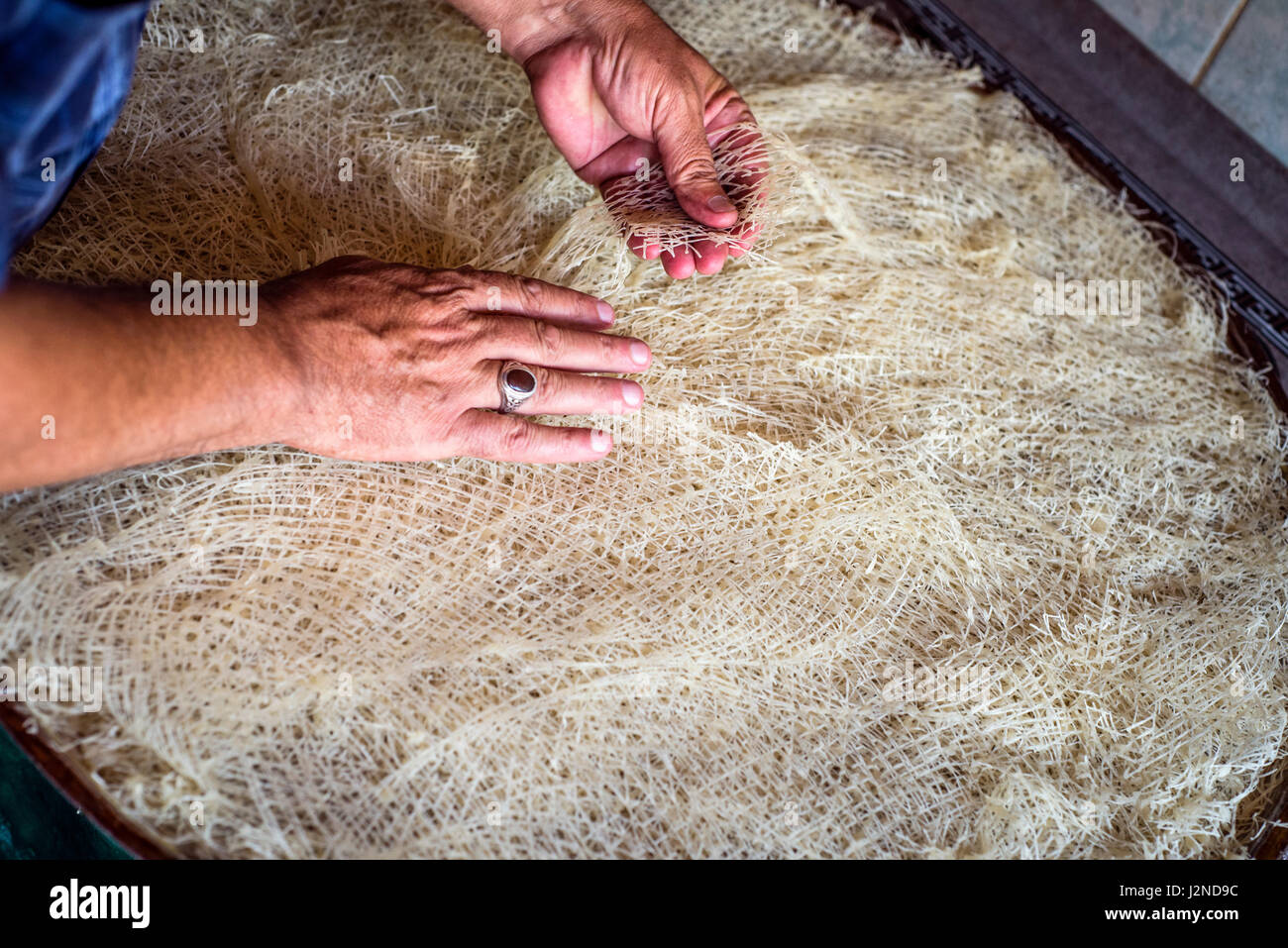 Rustam Hasanov, a baklava master, prepares the pastry at his kitchen ...