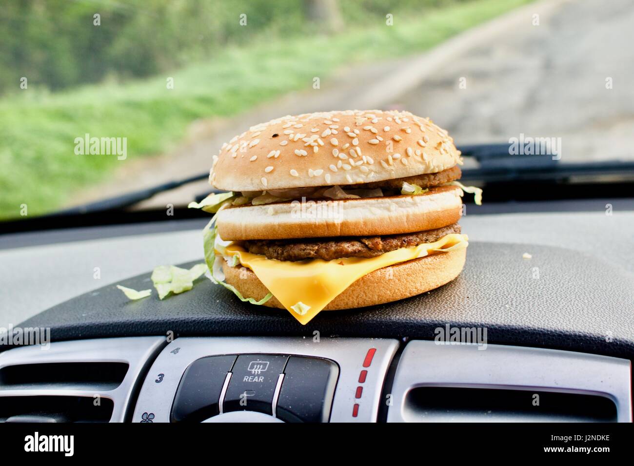 Tasty cheeseburger on the car Stock Photo - Alamy