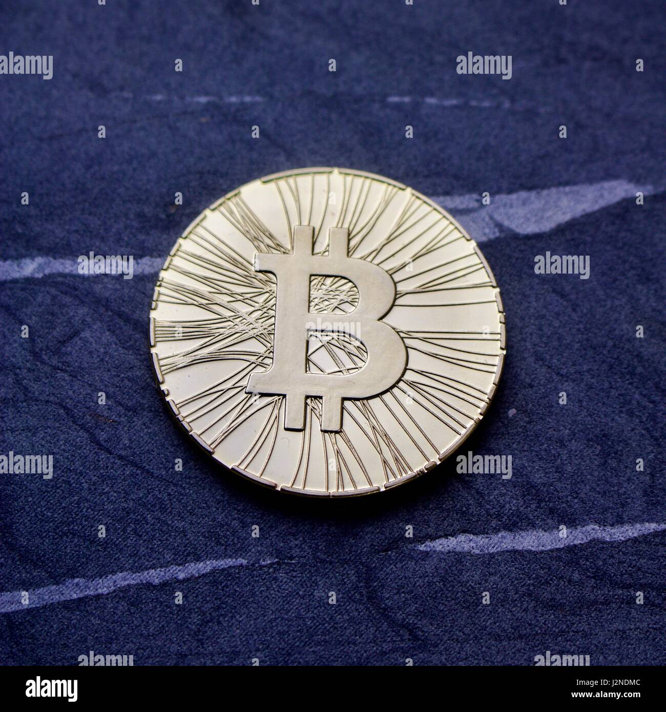 Bitcoin physical coin on a blue pattern Stock Photo - Alamy