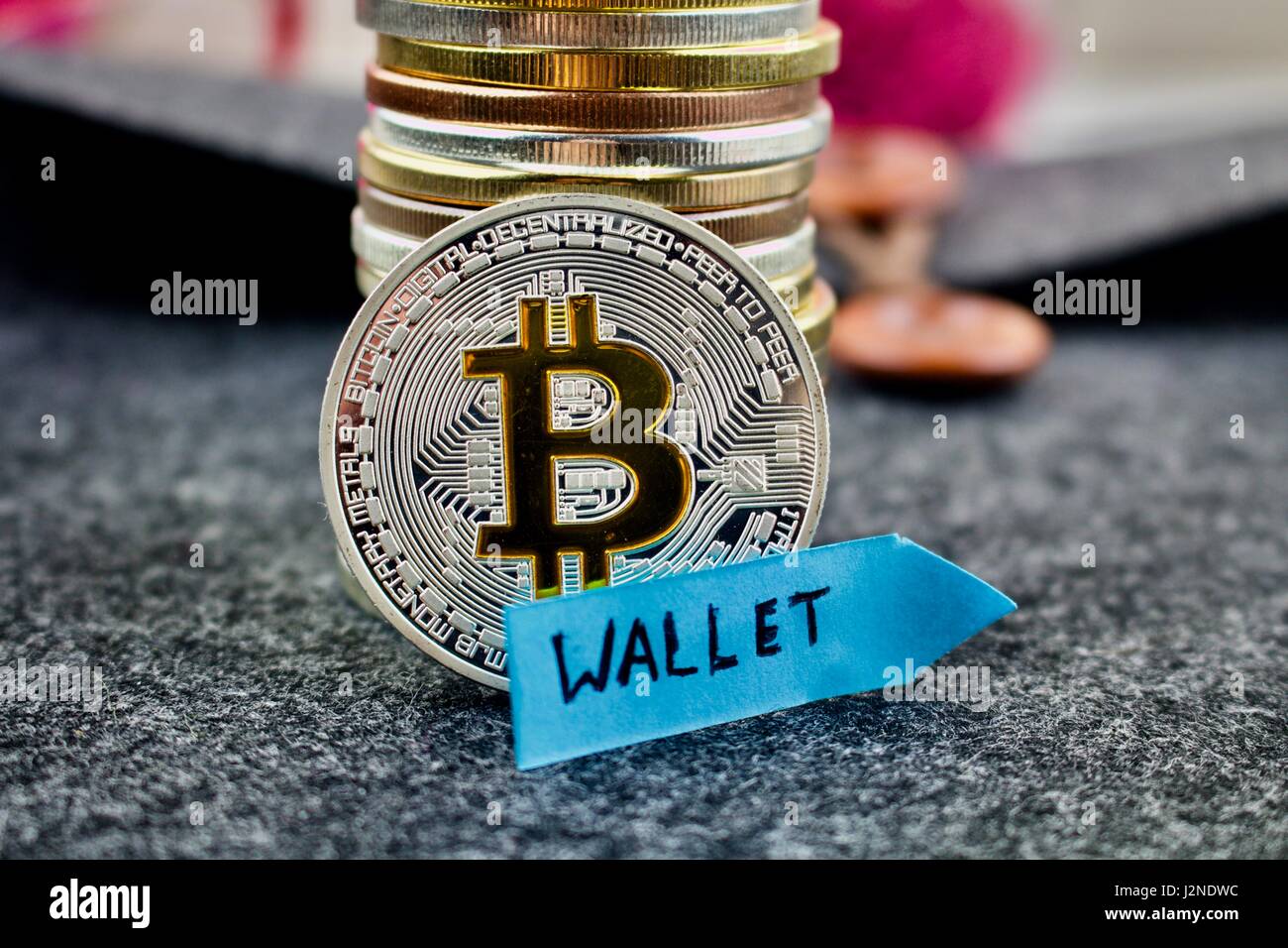 Digital currency physical silver bitcoin coin and blue sign wallet ...