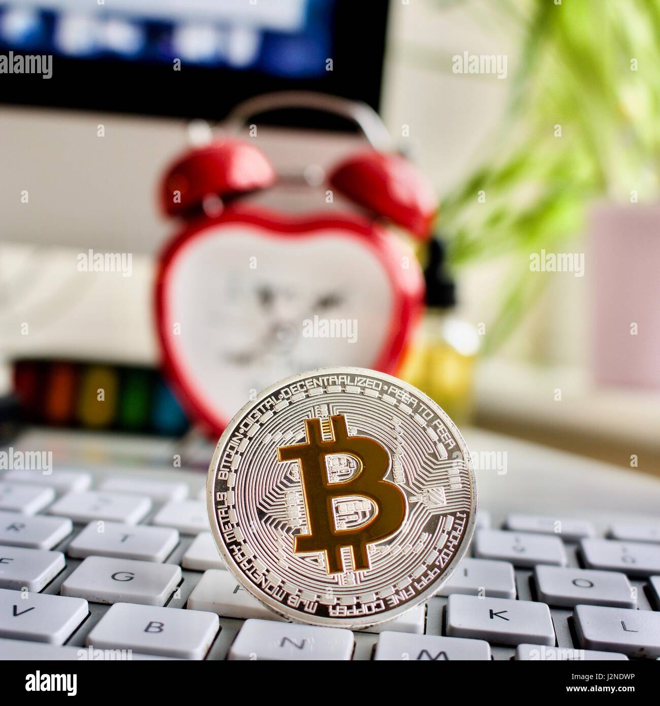 Cryptocurrency physical silver bitcoin coin, keyboard, screen and clock ...