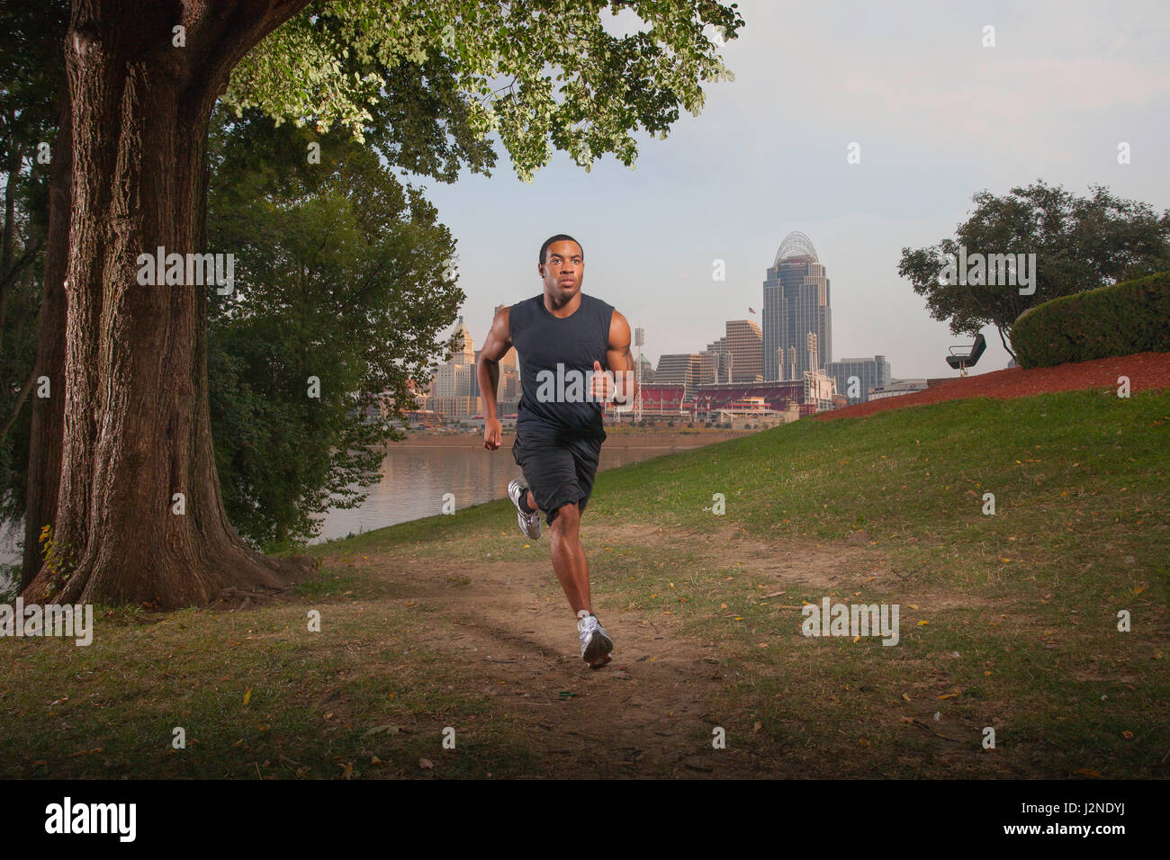 Black man running through a park with the City of Cincinnati and the ...