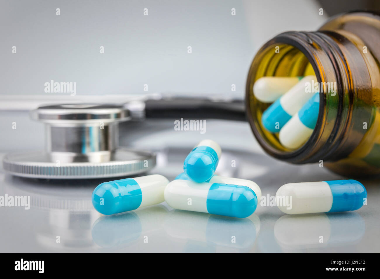 Blue and white pills, container transparent Stock Photo - Alamy
