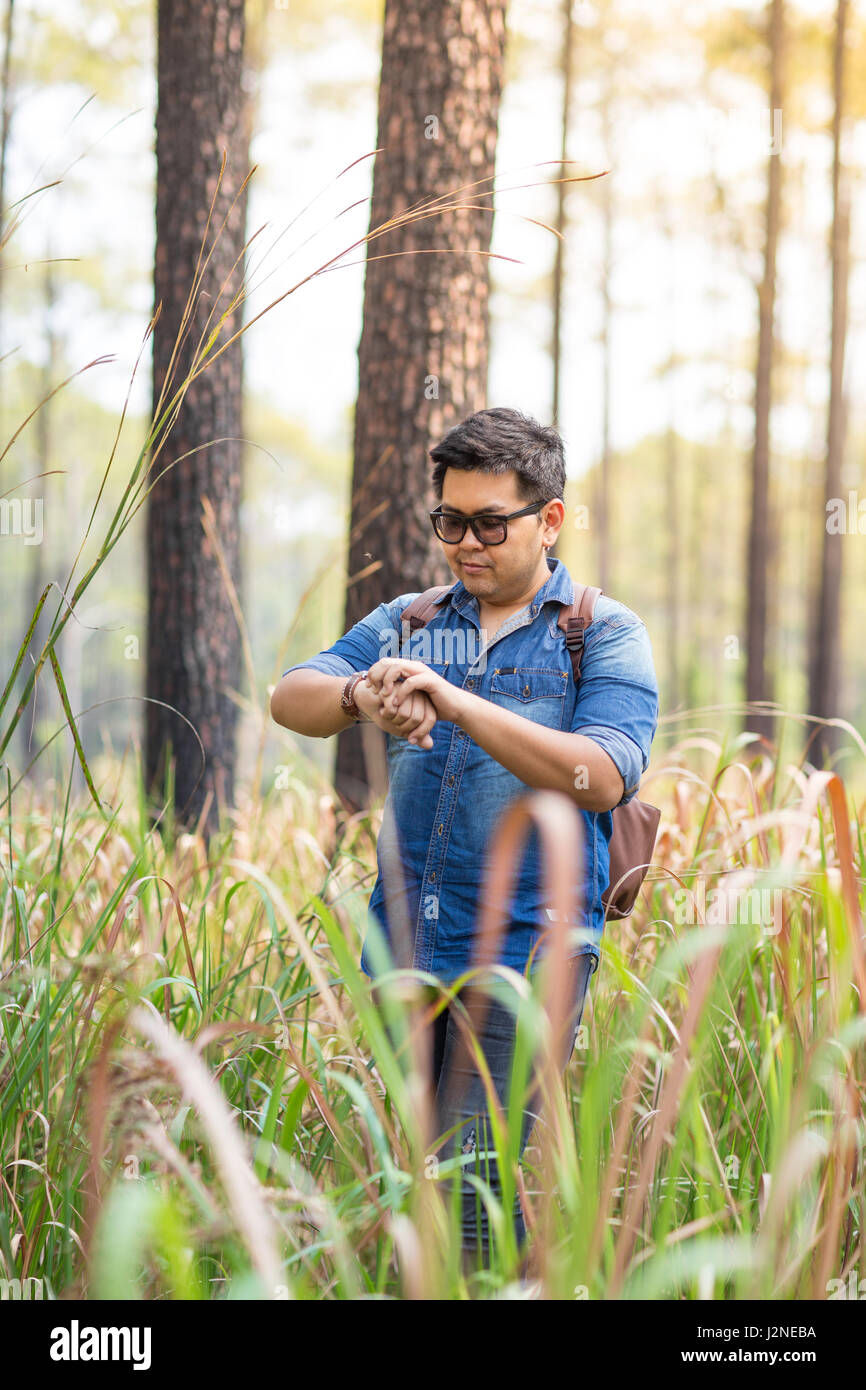 A man checking something on his watch or waiting for someone in the ...