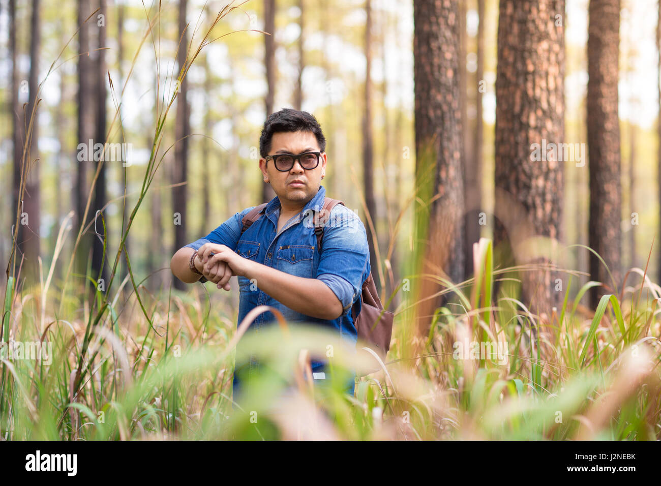A man checking something on his watch or waiting for someone in the ...