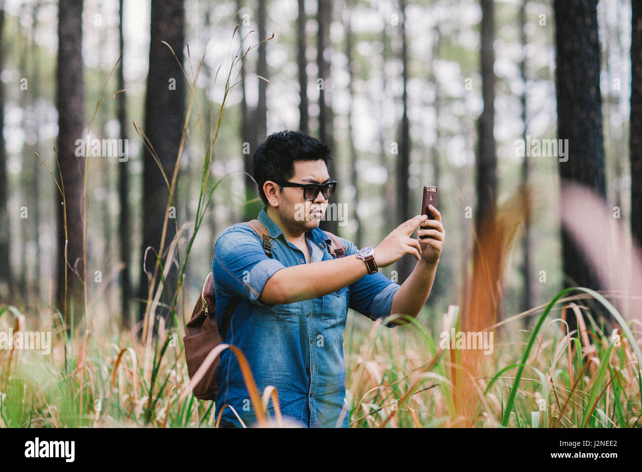 A man with his mobile smart phone searching for reception signal in the ...