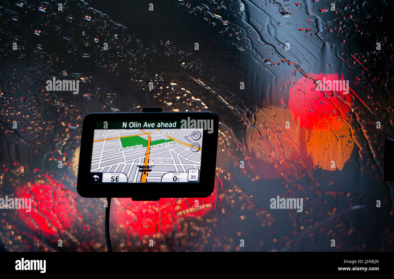 GPS Navigator with a map of the city with streets and roads in night ...