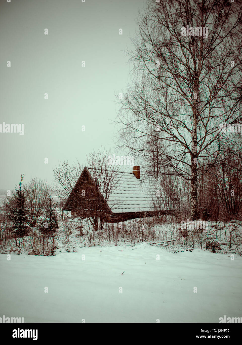 small rural cottage in winter in countryside - retro vintage look Stock ...