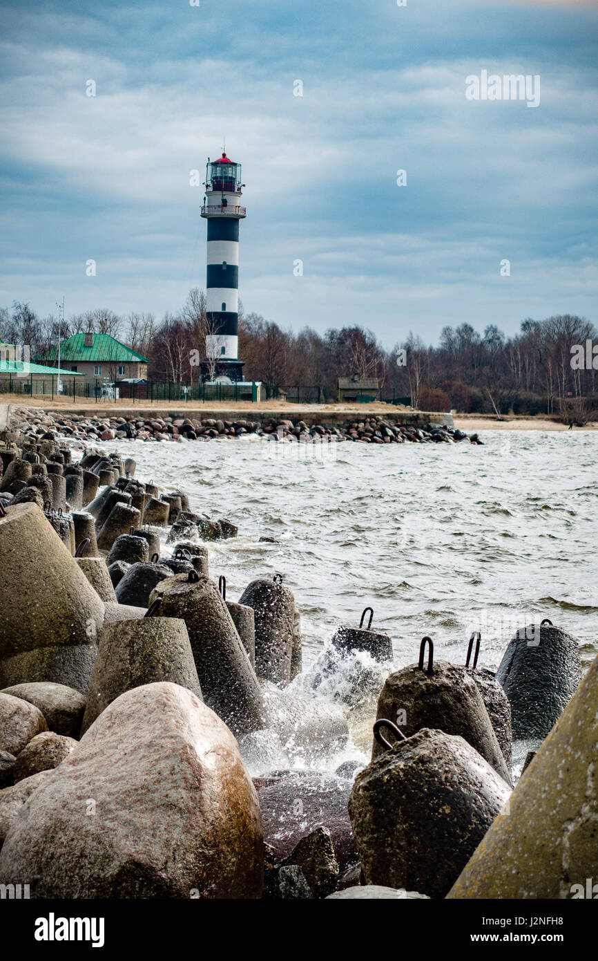 Seascape. Lighthouse and pier on a windy day Stock Photo - Alamy