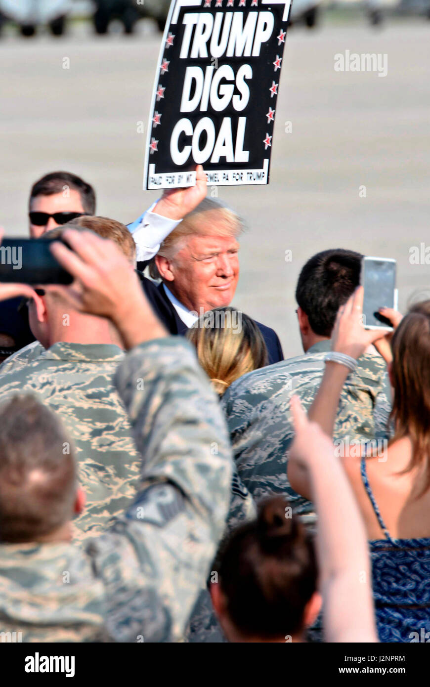 U.S President Donald Trump holds up a sign supporting Coal as he greets ...