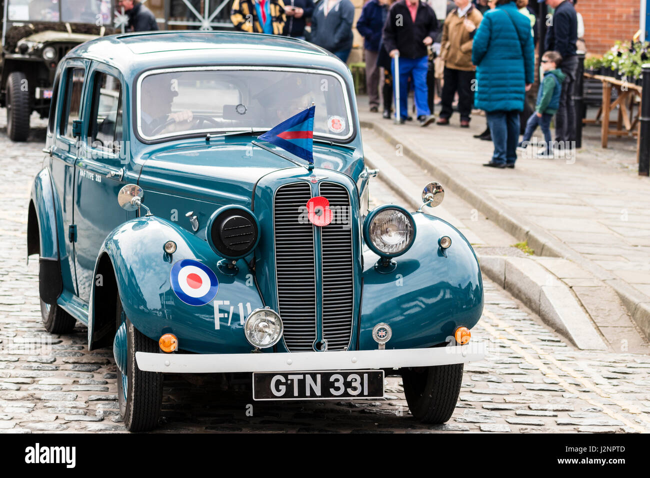 Salute to the 40s event. A vintage RAF Hillman blue car driving along ...