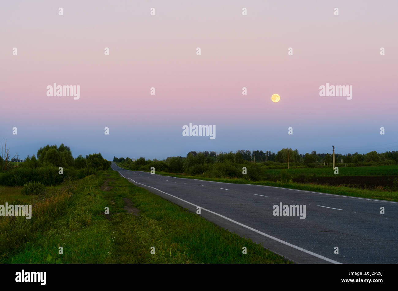 Highway under a full moon Stock Photo - Alamy