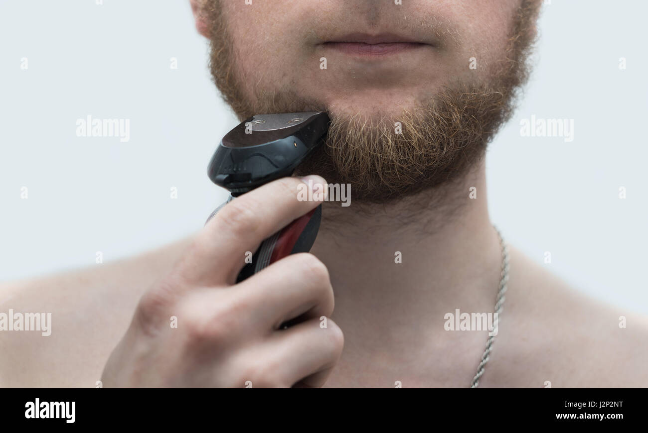 young man shaving his beard Stock Photo - Alamy