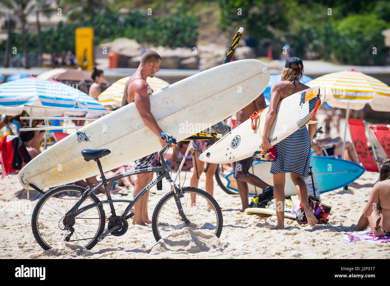 RIO DE JANEIRO - FEBRUARY 10, 2017: Young Brazilian surfers carry their ...