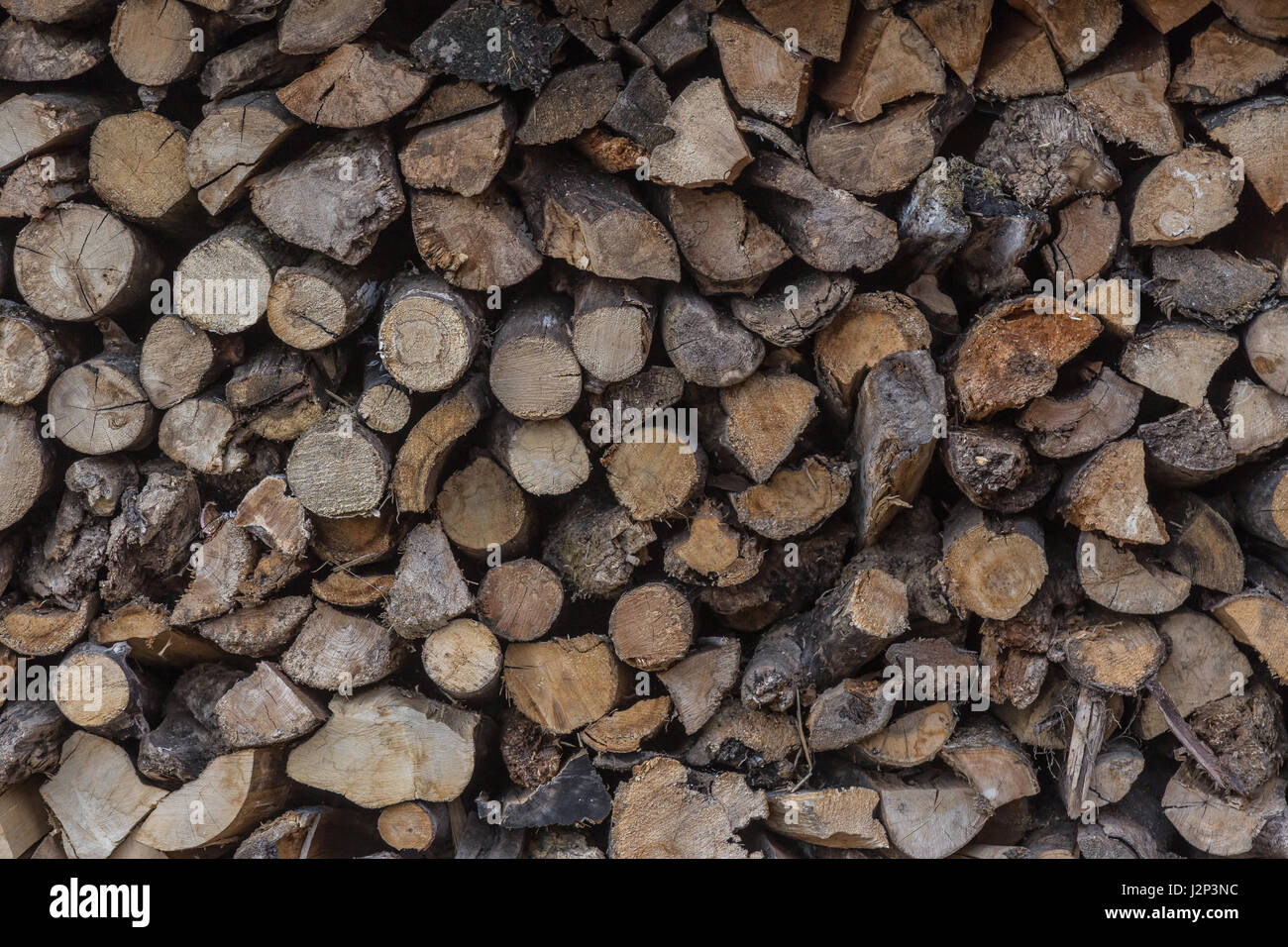 Stacking pile of rough cut firewood, various in sizes Stock Photo - Alamy