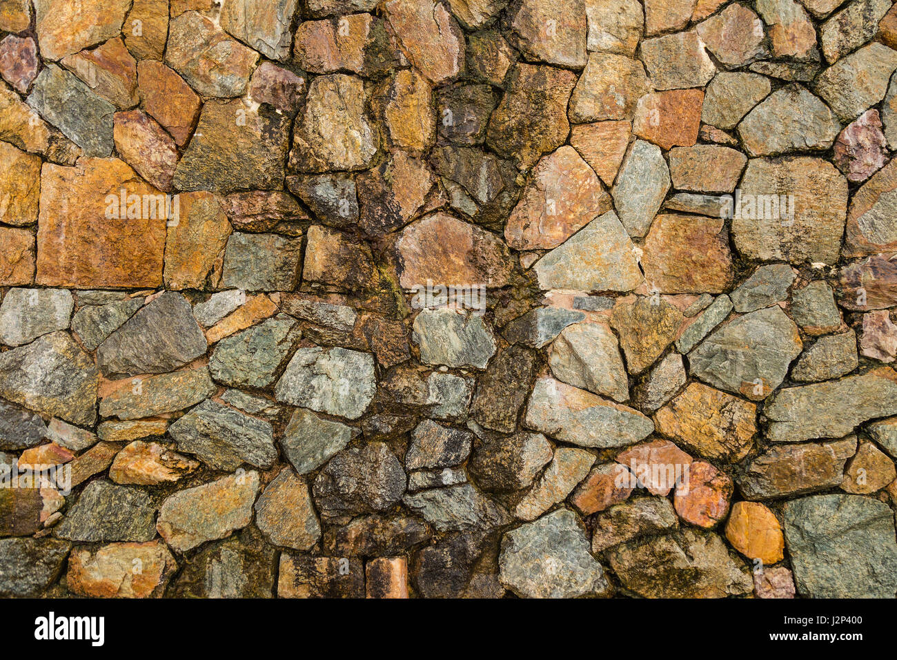 Rough wet and dirty stone wall in random pattern Stock Photo - Alamy