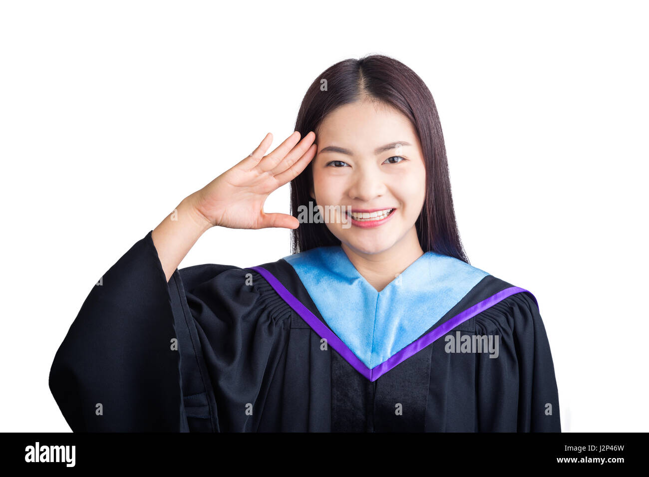 Young smiling asian female graduate student in her gown saluting ...
