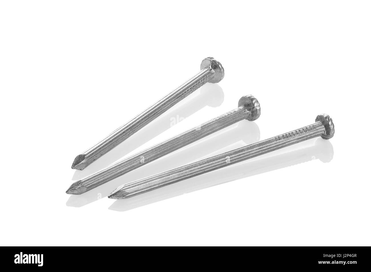 Three steel concrete nails on white background with light reflection ...