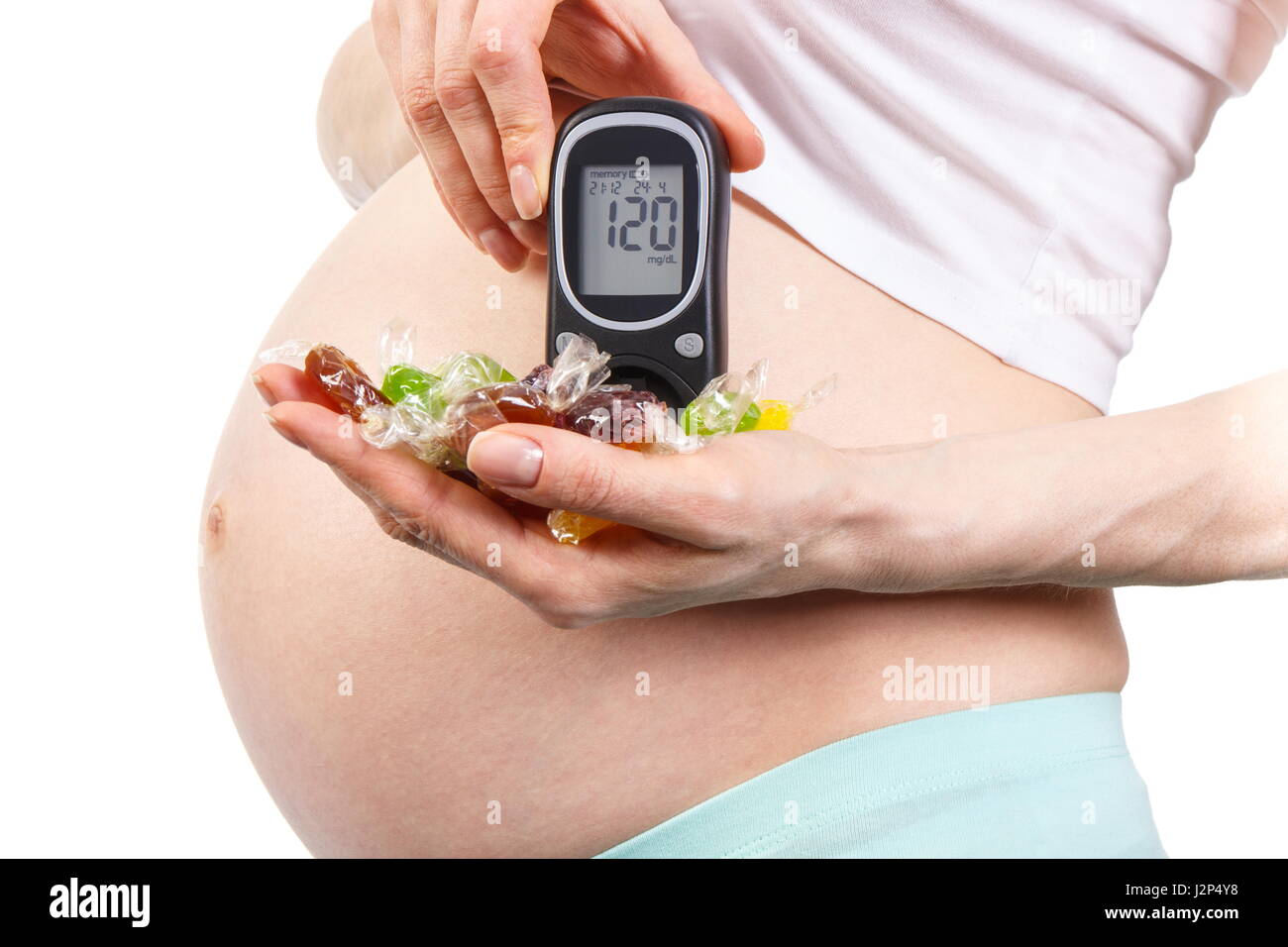 Pregnant woman holding colorful candies and glucose meter with result ...