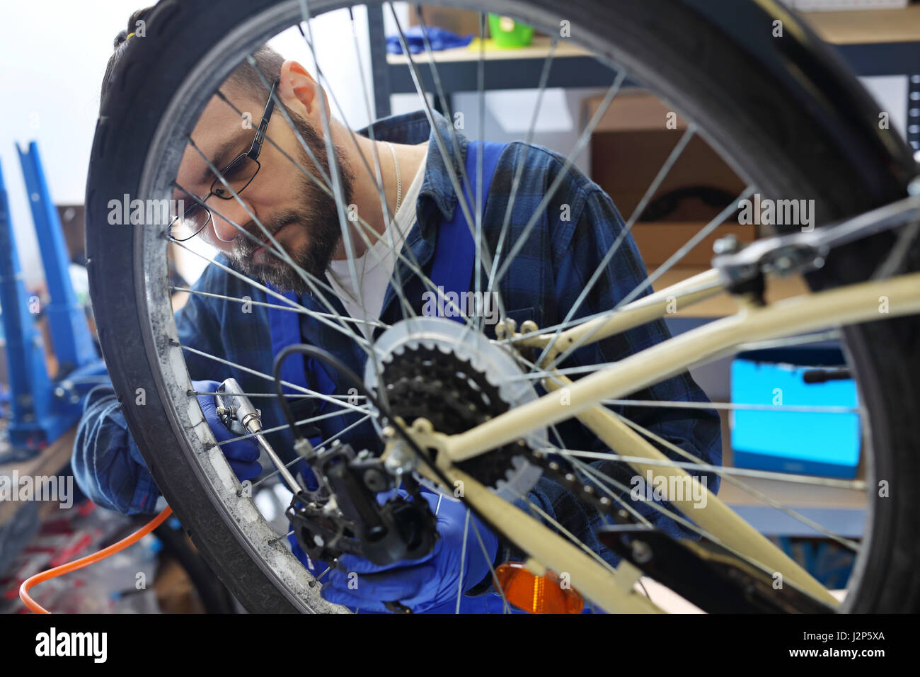 Pumping the bicycle wheel. Pumping the bike. The mechanic in the bike ...